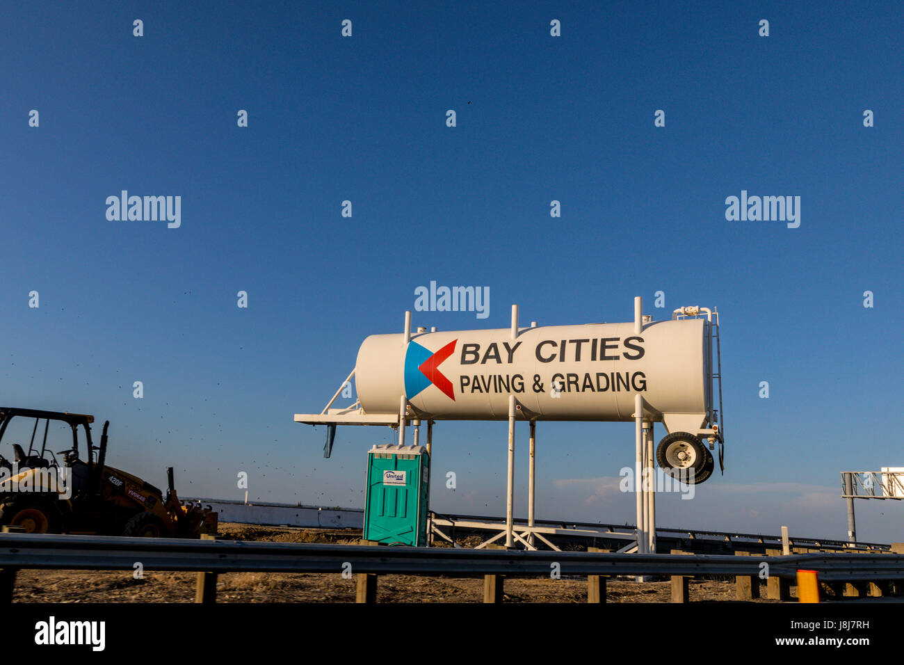 A portable water storage tank for a road construction project along ...