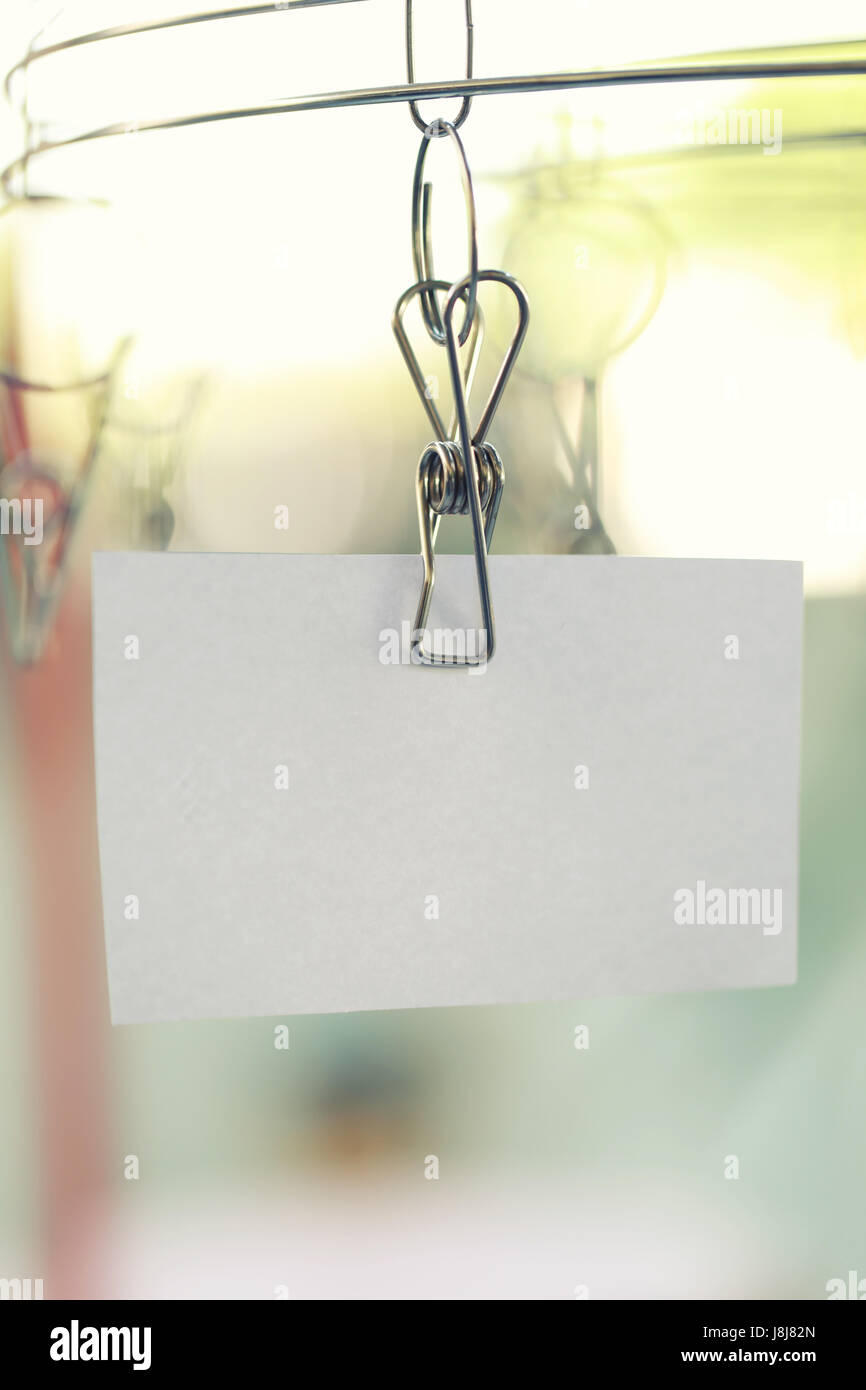 white paper notes hanging in a clothesline on green bokeh background ...