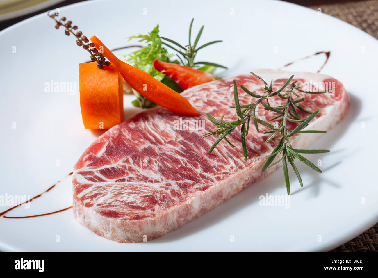 Delicious Raw Marbled Steak in the White Plate Stock Photo - Alamy