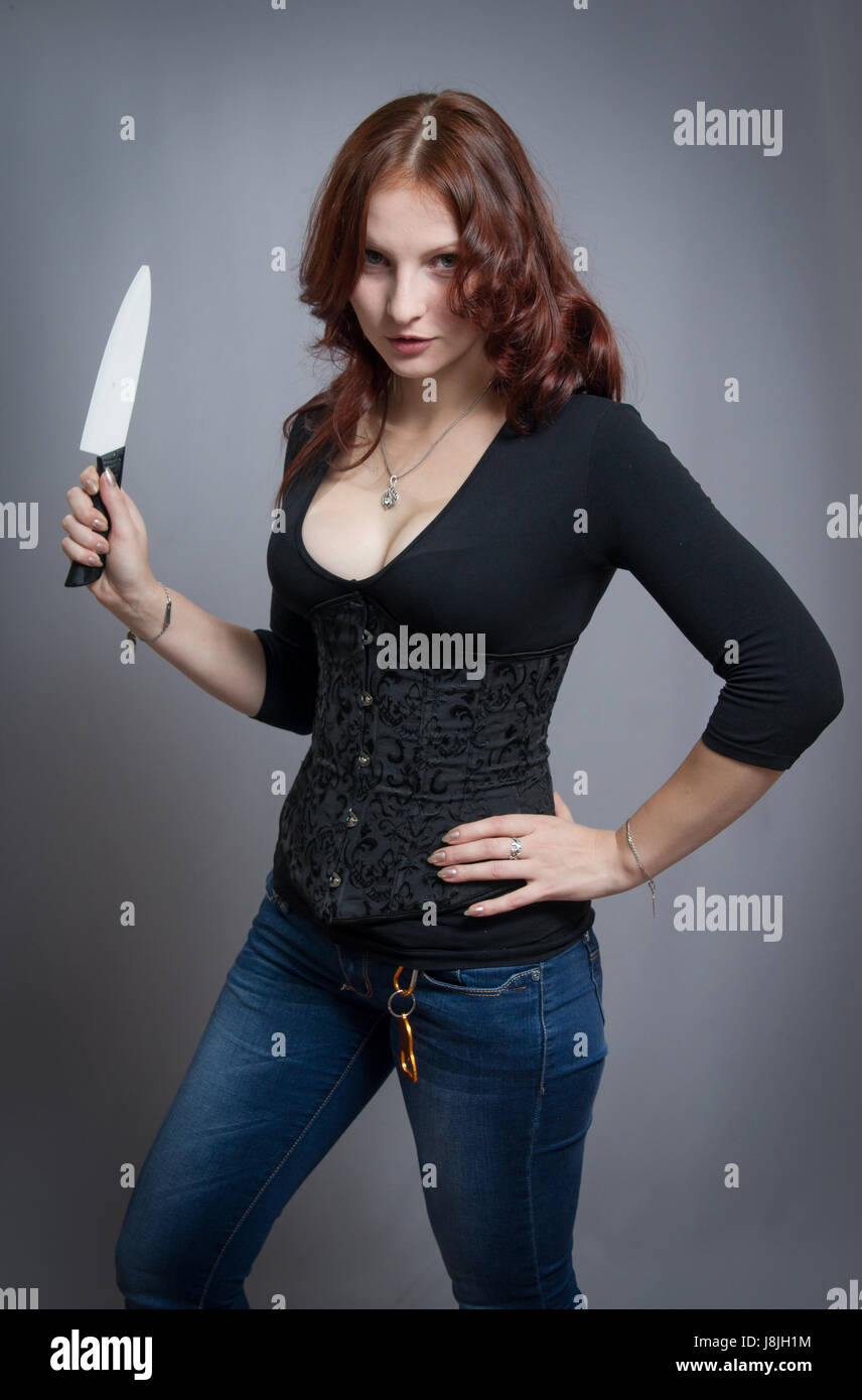 red-haired girl holding a big knife Stock Photo - Alamy