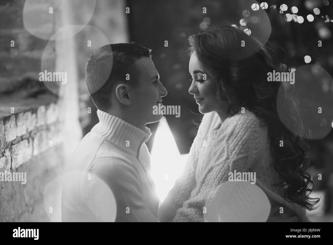 Young couple staying at home together on holiday evening and sitting on ...