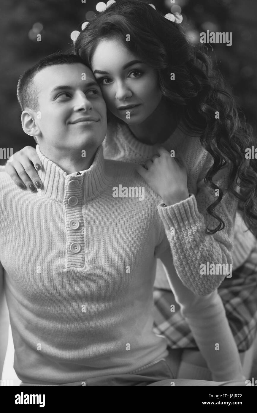 Young couple staying at home together on holiday evening and sitting on ...