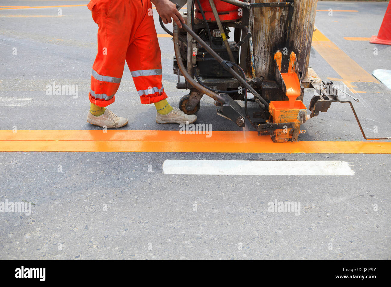 machine and worker at road construction use for road and traffic sign ...