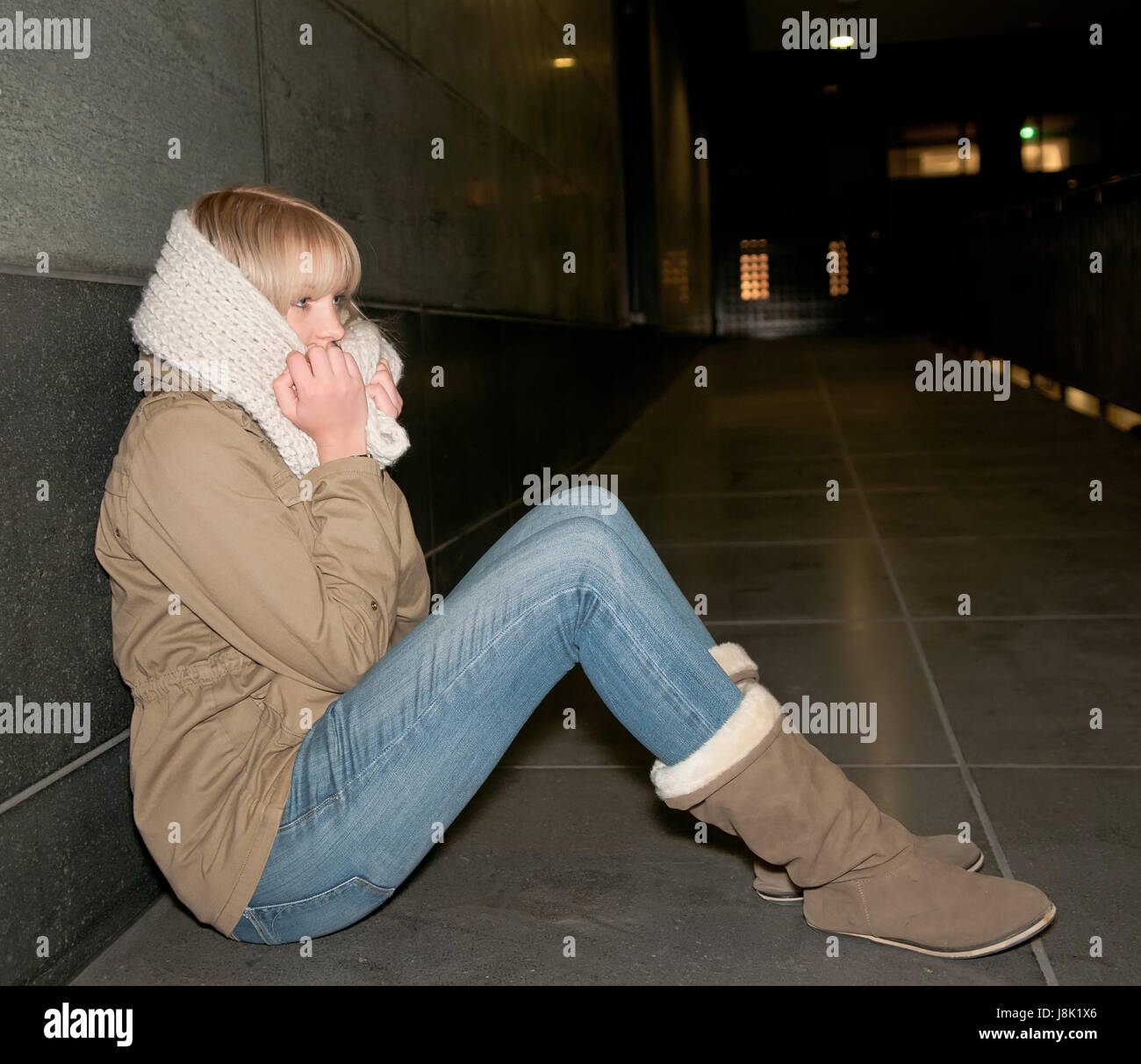 sad young woman sitting on the road Stock Photo - Alamy