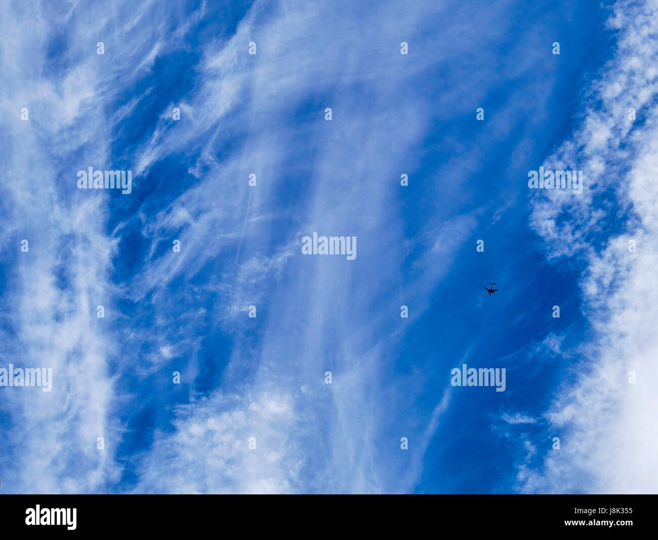 Blue sky with cirrus clouds and aircraft Stock Photo - Alamy