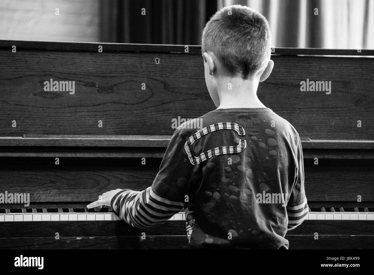 Boy playing piano at recital hi-res stock photography and images - Alamy