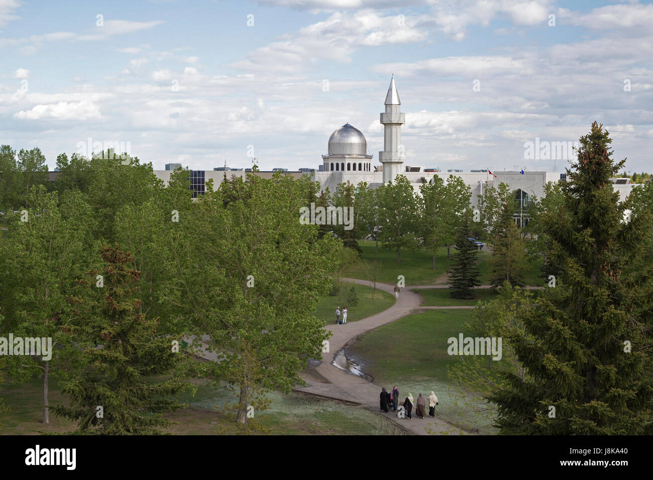 People walking through Prairie Winds Park towards Baitun Nur Mosque of ...