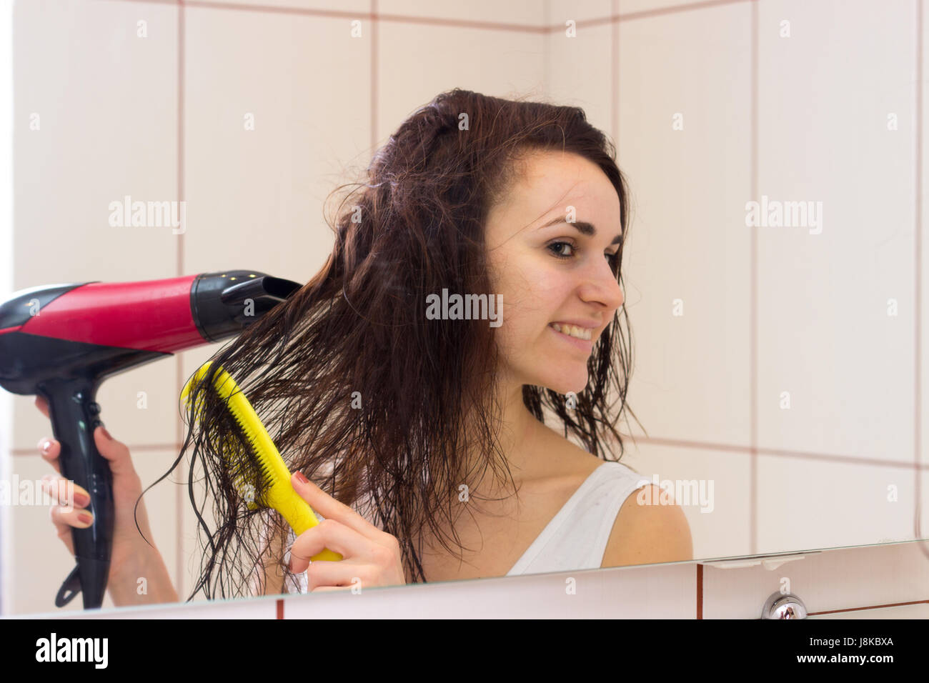 Woman drying hair in bathroom hi-res stock photography and images - Alamy
