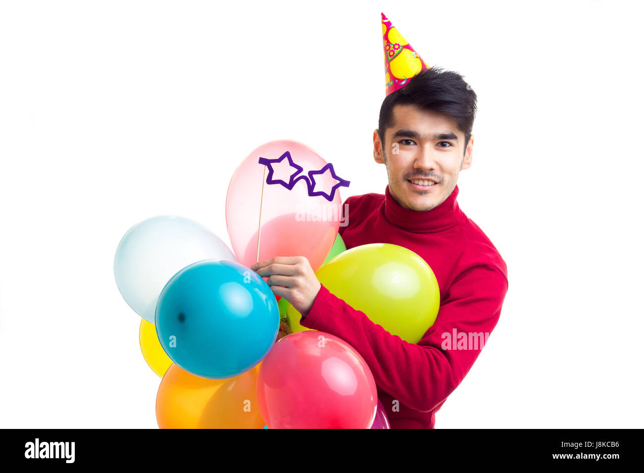 Young man holding balloons Stock Photo - Alamy