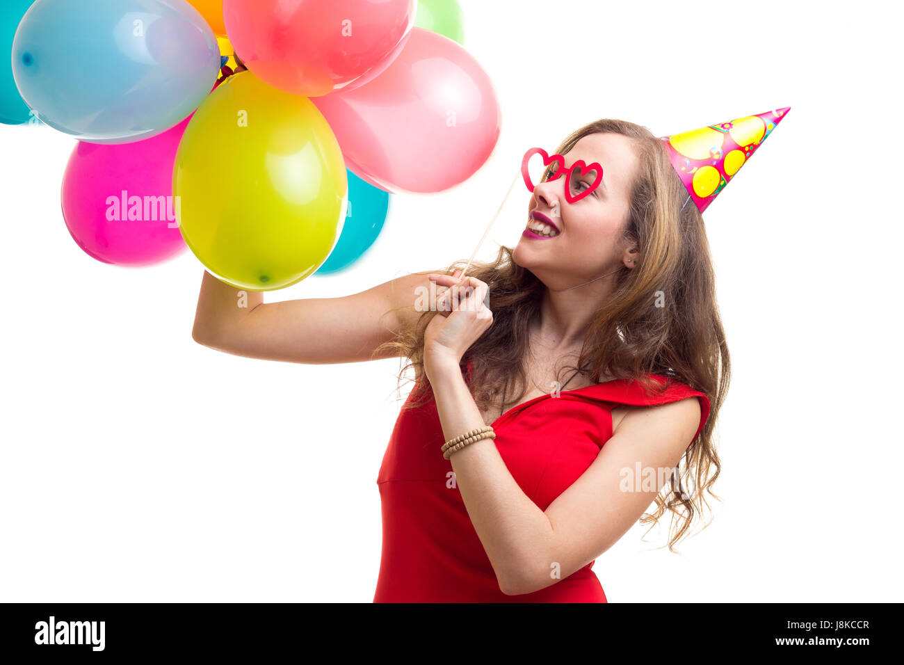 Young woman holding balloons Stock Photo - Alamy