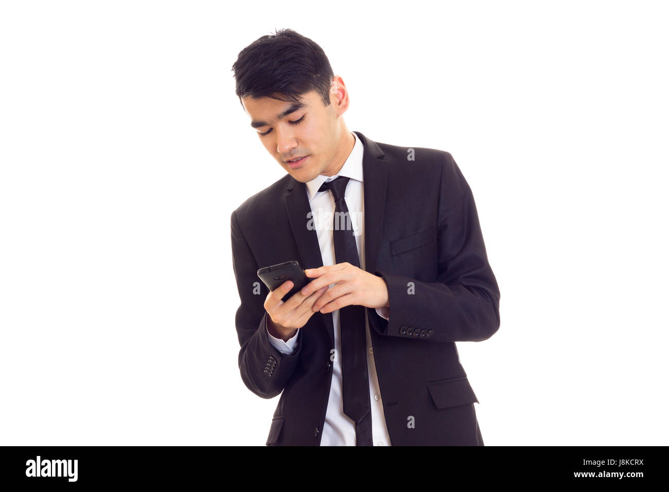 Young man in suit talking on the phone Stock Photo - Alamy