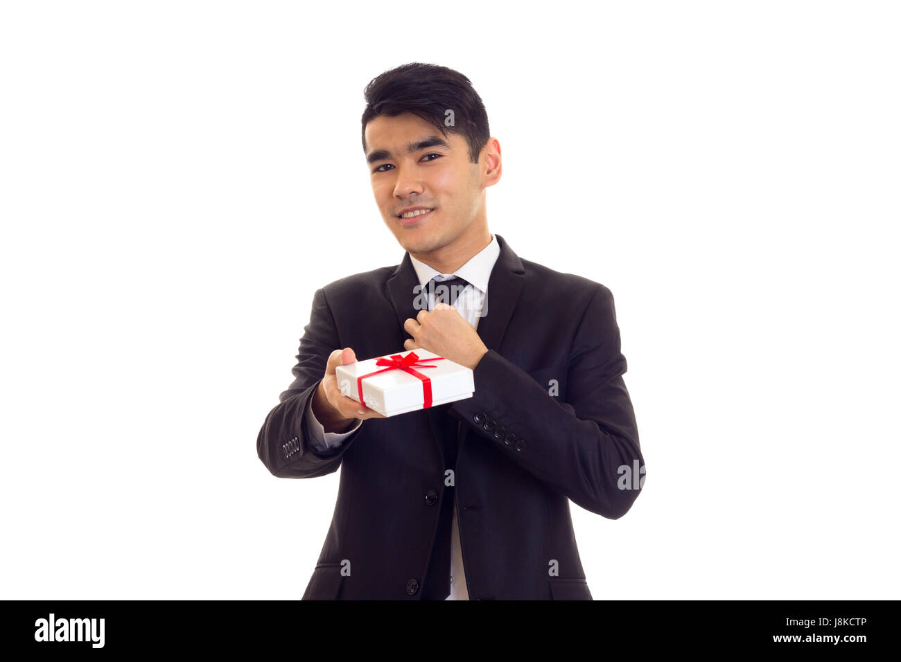 Young man in suit holding a present Stock Photo - Alamy
