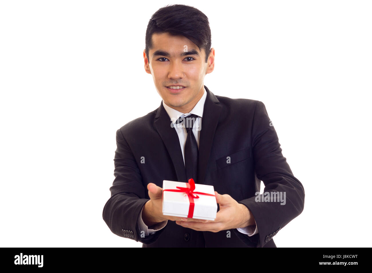 Young man in suit holding a present Stock Photo - Alamy