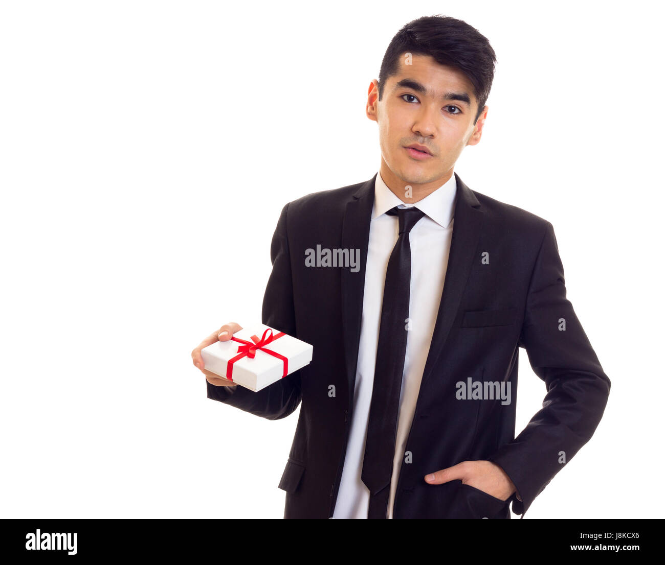 Young man in suit holding a present Stock Photo - Alamy