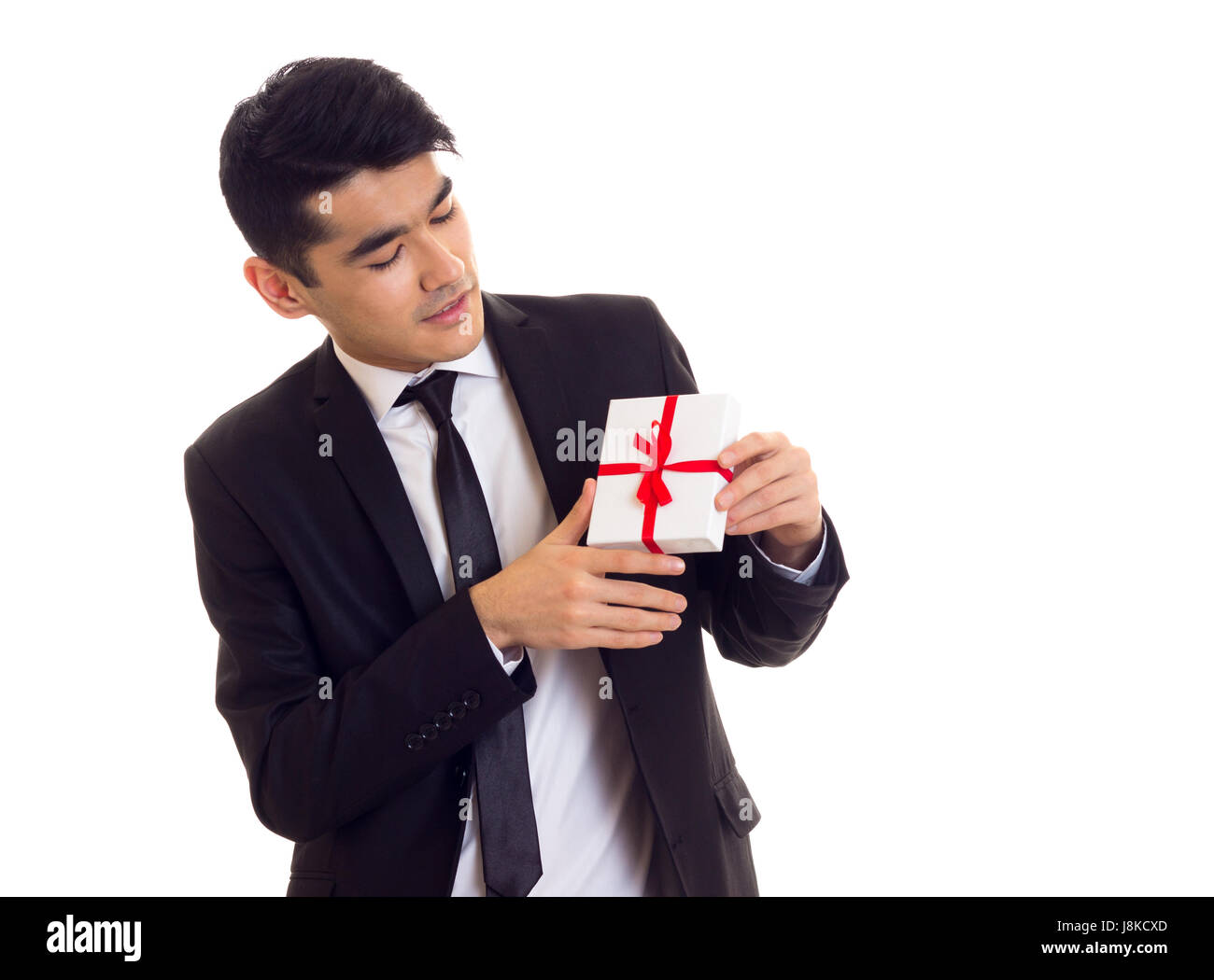 Young man in suit holding a present Stock Photo - Alamy