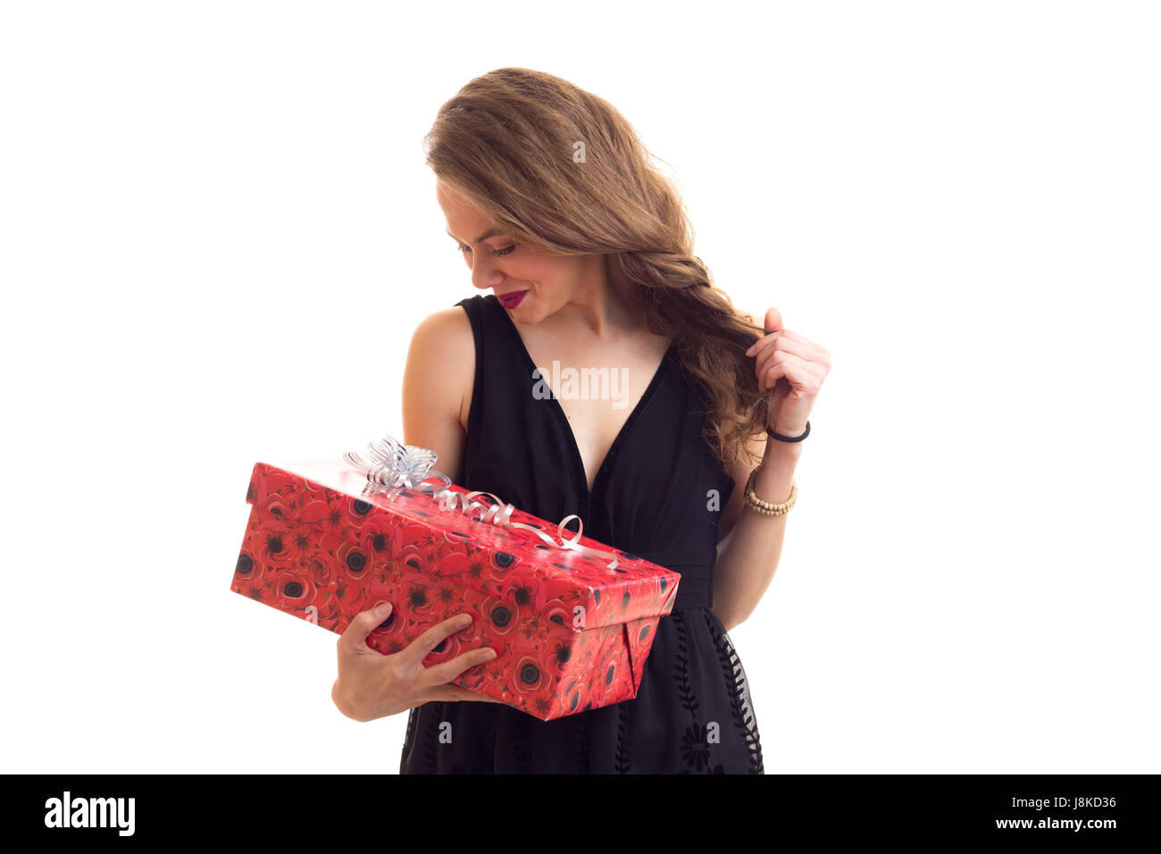 Young woman holding a present Stock Photo - Alamy