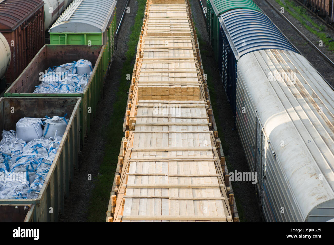 long trains with industrial goods stand on the rails Stock Photo - Alamy