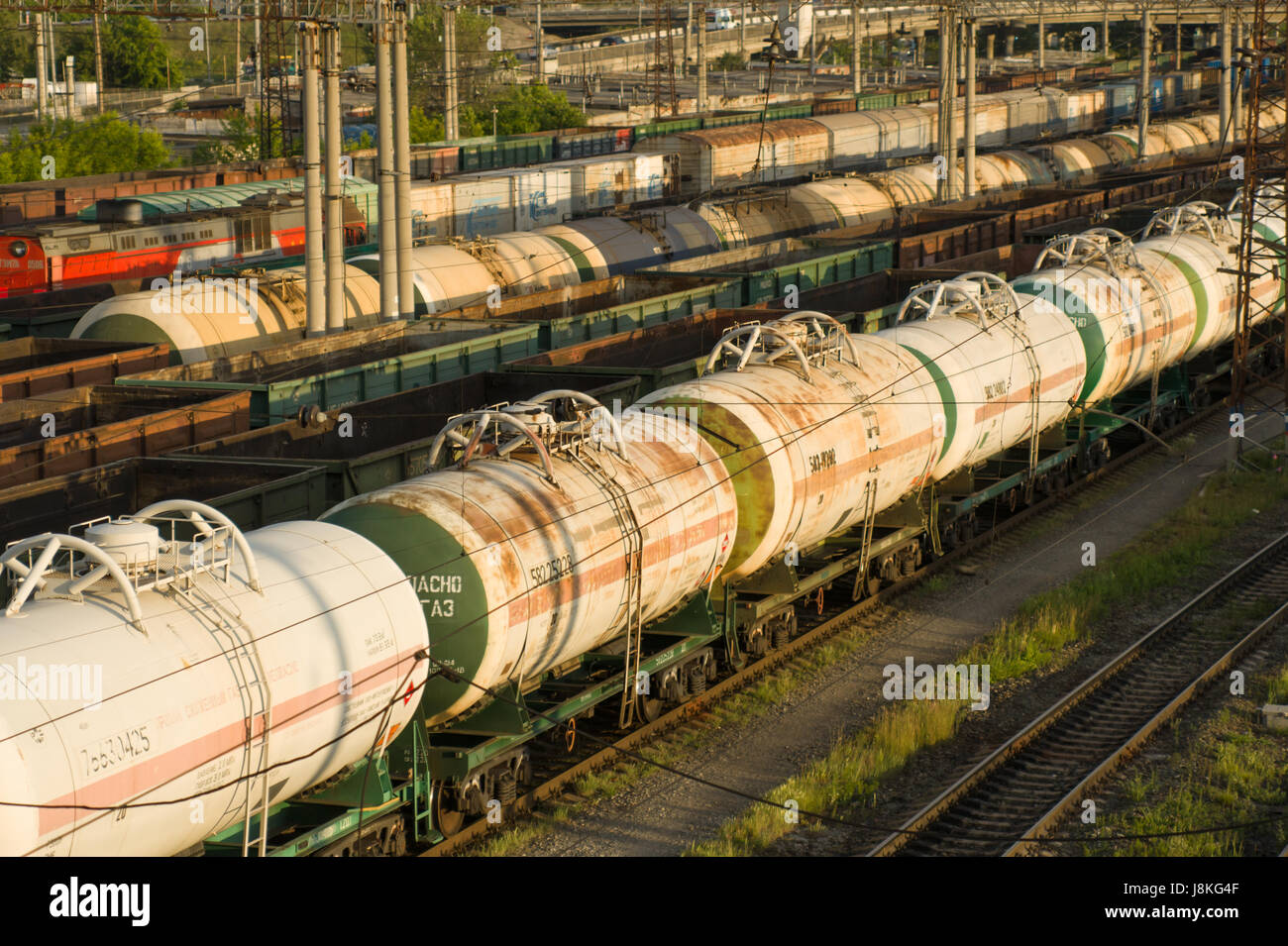 long trains with industrial goods stand on the rails Stock Photo - Alamy
