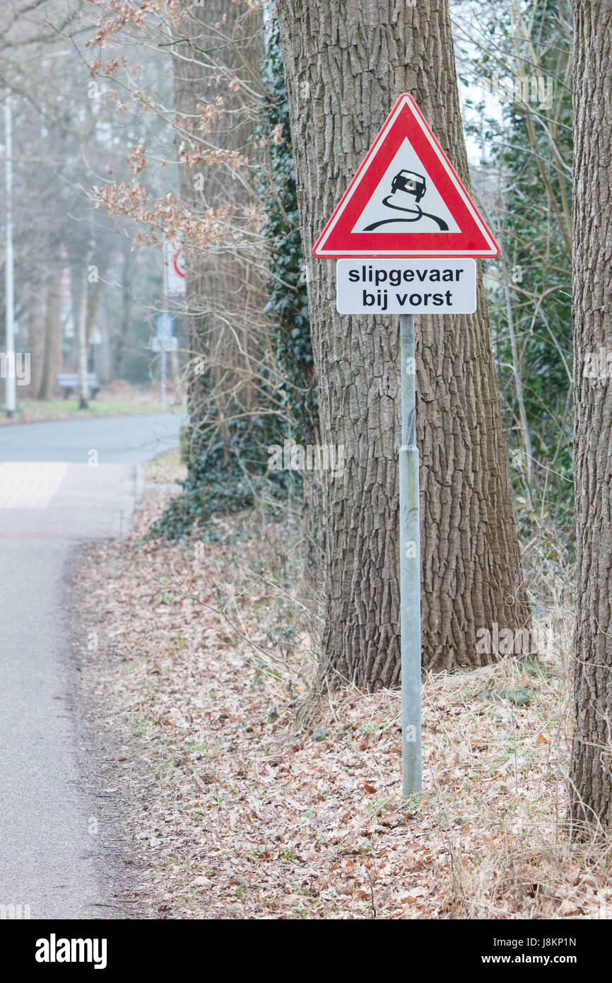 Road sign warning against slippery road due to snow ice (dutch Stock ...