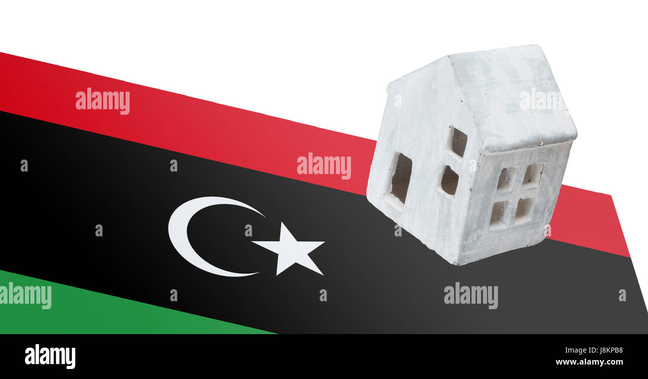 Small house on a flag - Living or migrating to Libya Stock Photo - Alamy