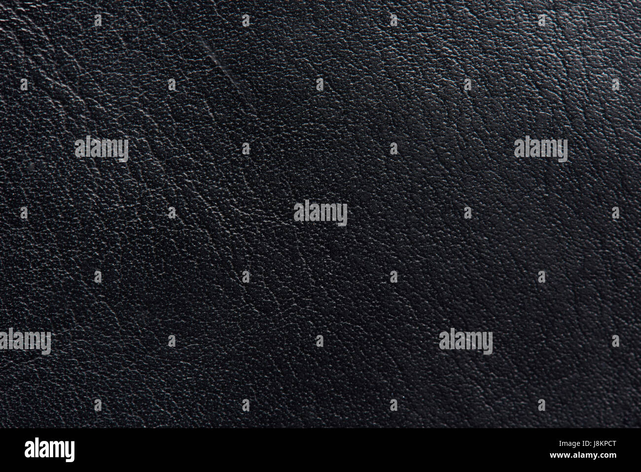 Real black leather background close-up. Macro of dark skin texture ...