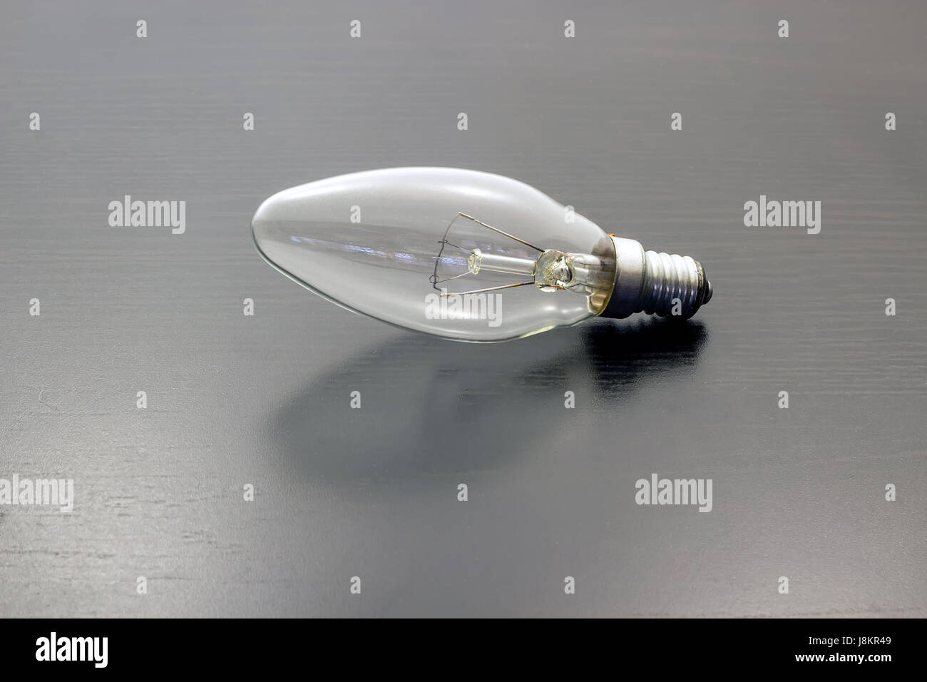 Light bulb turned off over black wooden background Stock Photo - Alamy