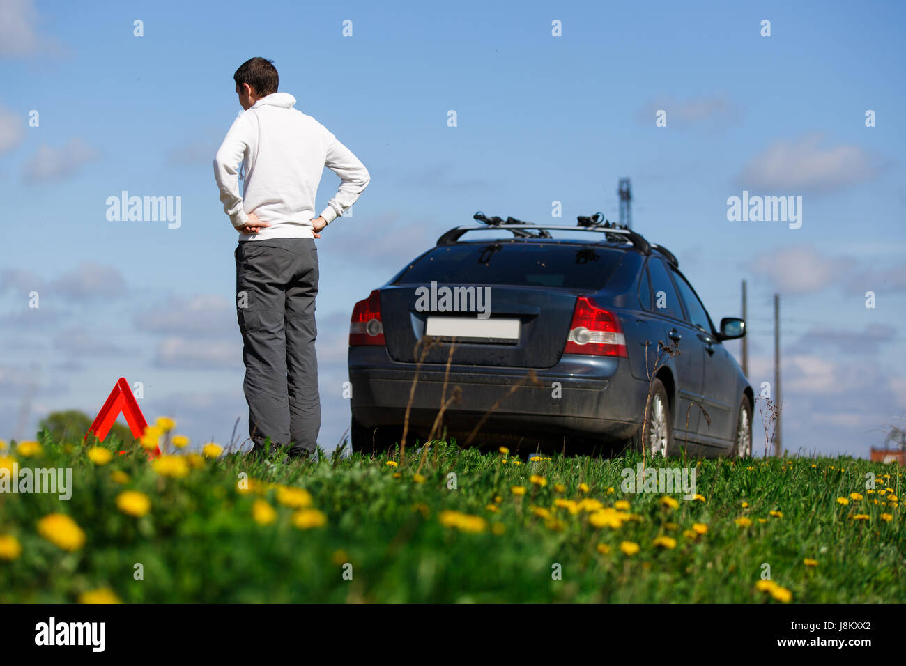 Man near car on road Stock Photo - Alamy