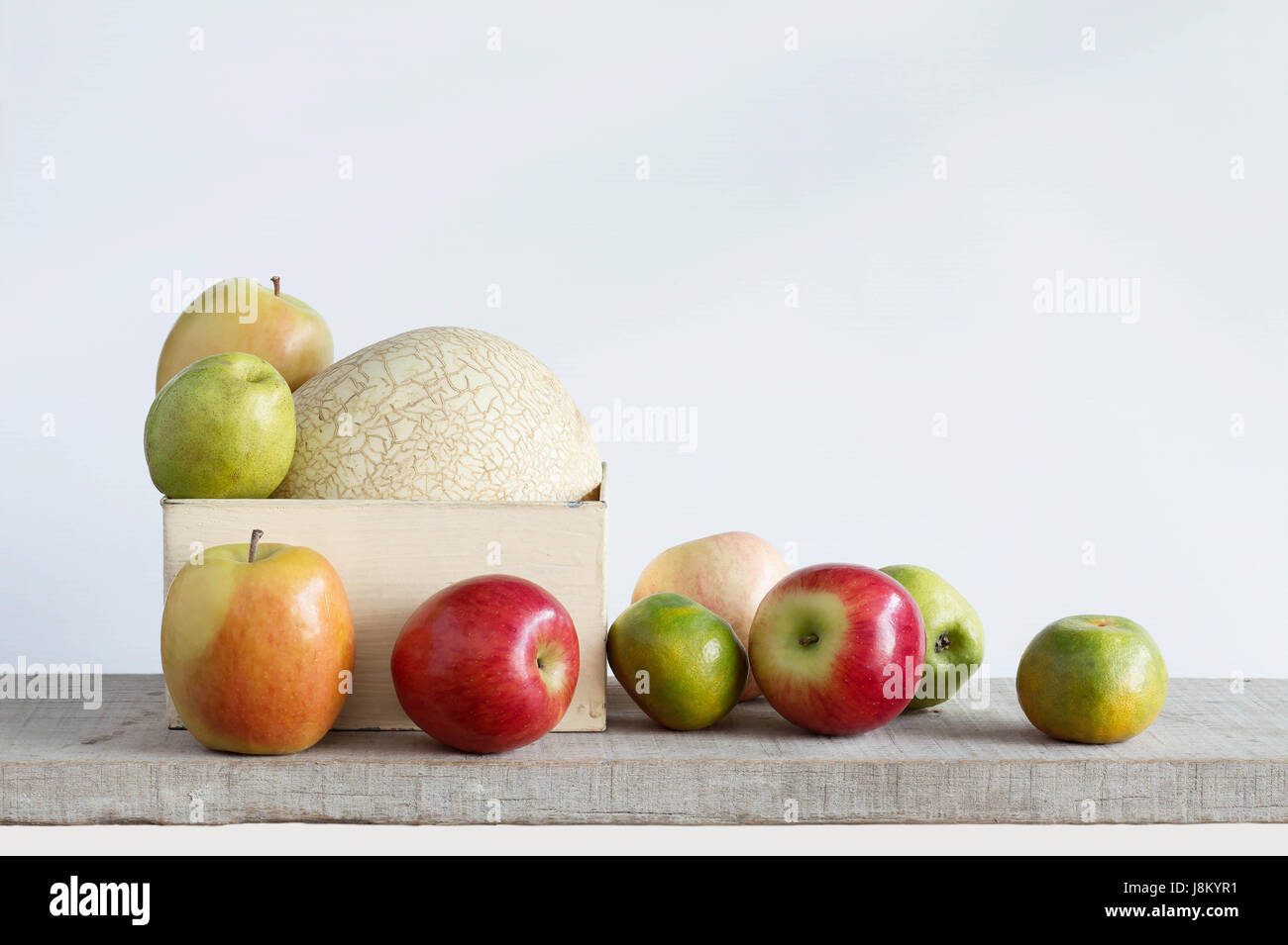 Apples and other fruits on wood with a white background Stock Photo - Alamy