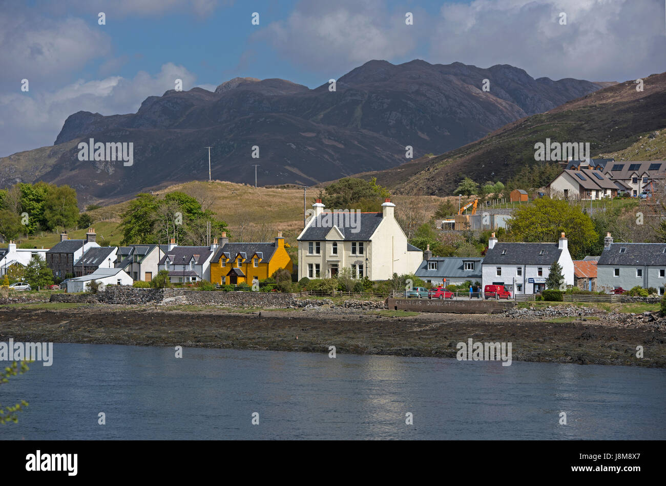 The Scottish north west coast sea front village of Dornie with ...