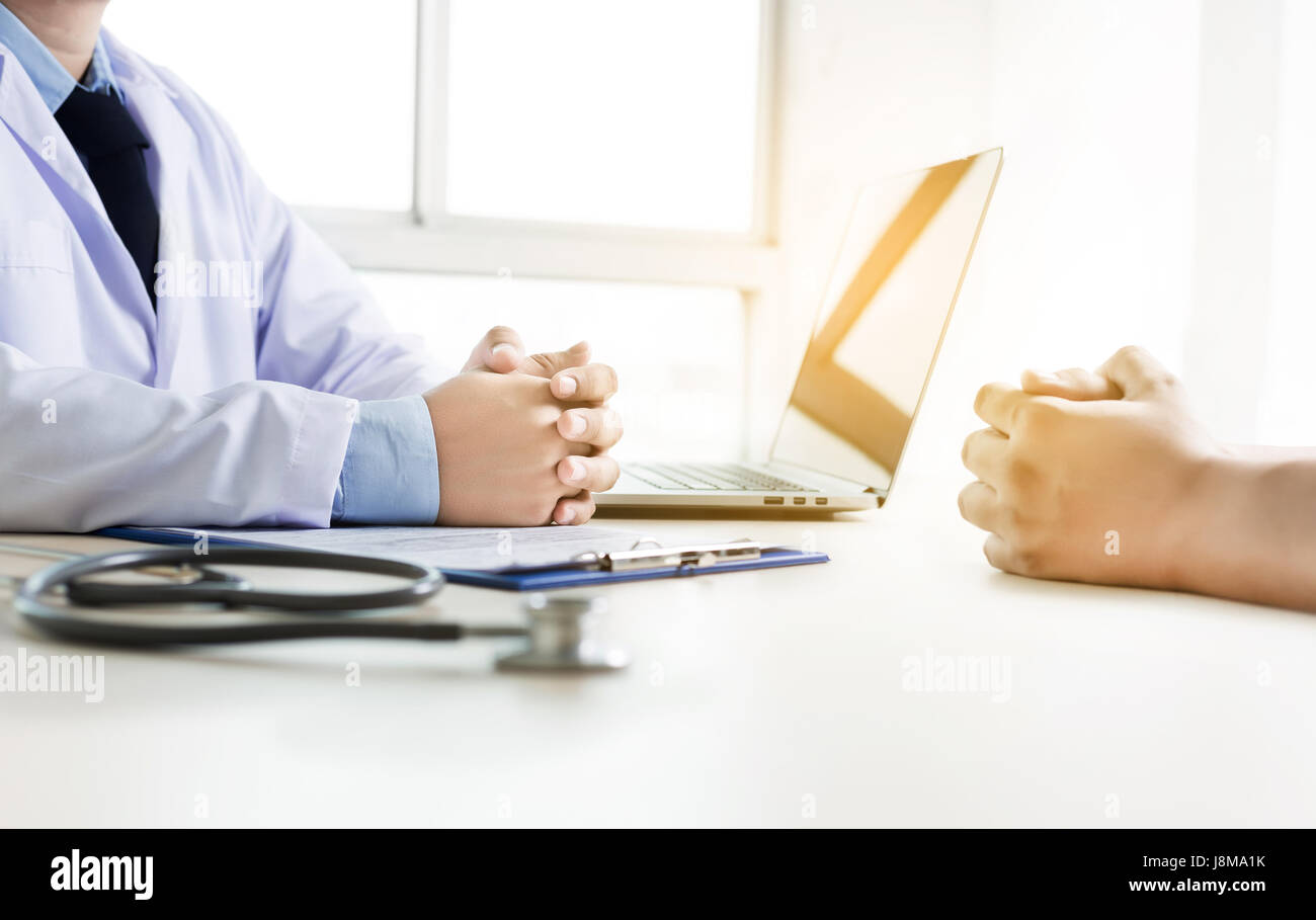 Doctor taking patient discussing hi-res stock photography and images ...