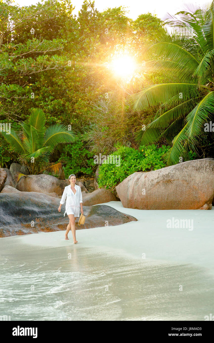 Beautiful woman enjoying the beautiful beachs of Praslin, Seychelles ...