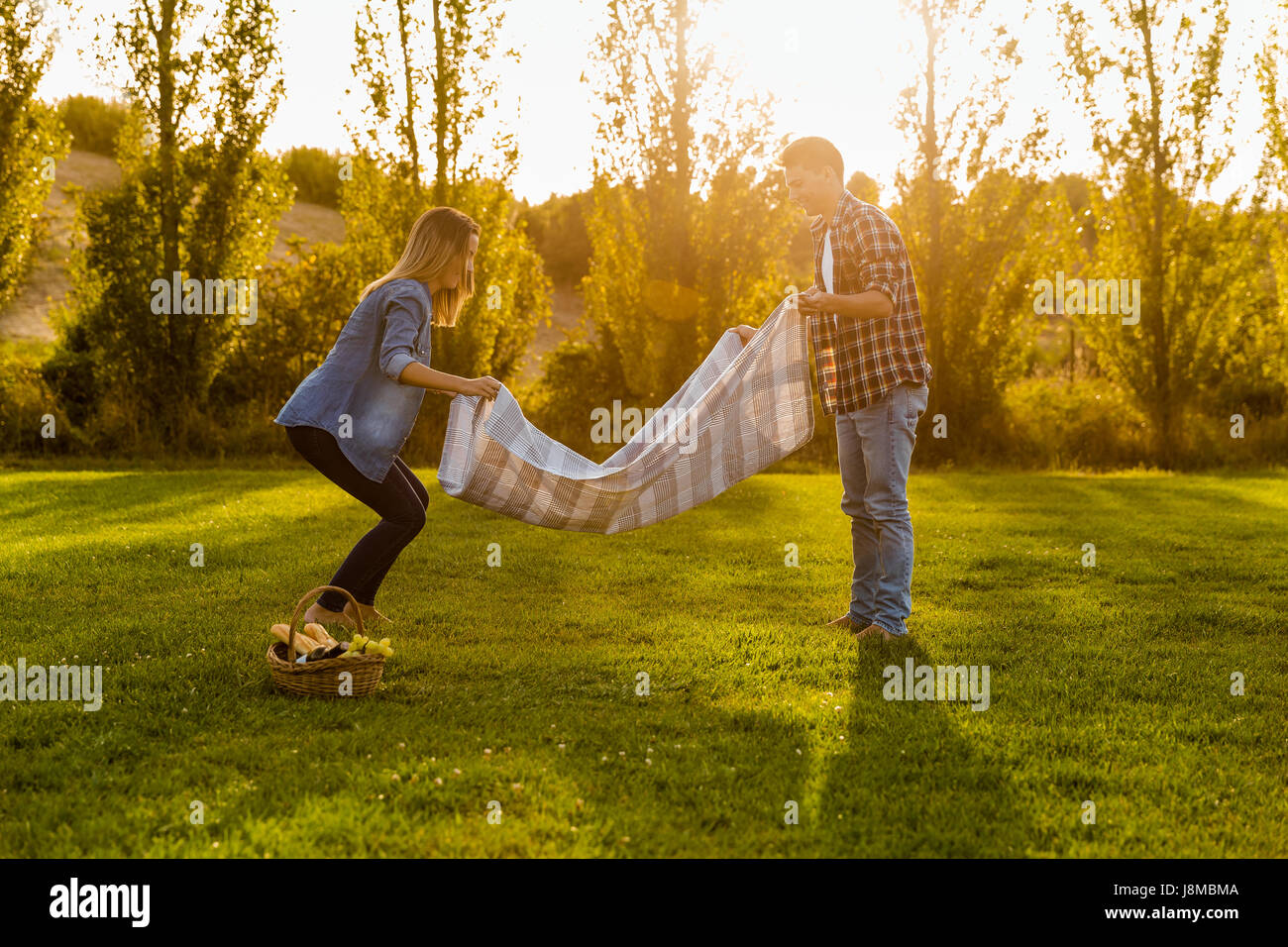 Happy couple getting ready for a picnic Stock Photo - Alamy