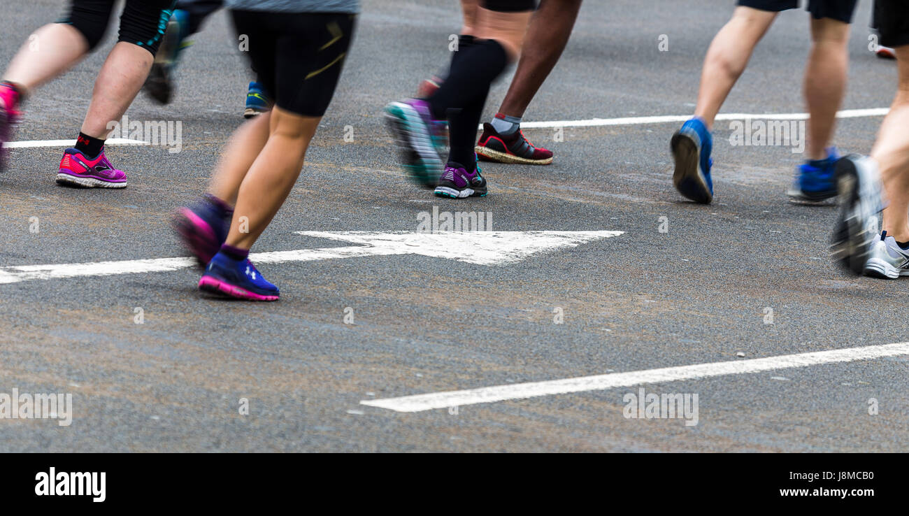 A slow shutter speed has been used to blur the motion of the feet of ...