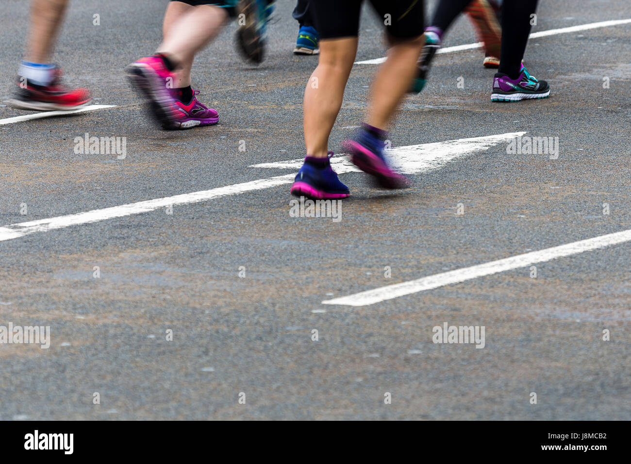 A slow shutter speed has been used to blur the motion of the feet of ...