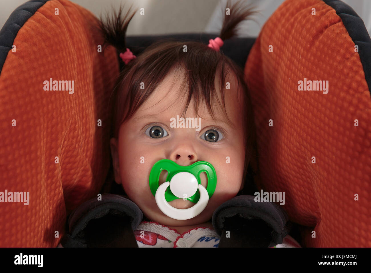 Cute adorable baby girl with baby's dummy Stock Photo - Alamy