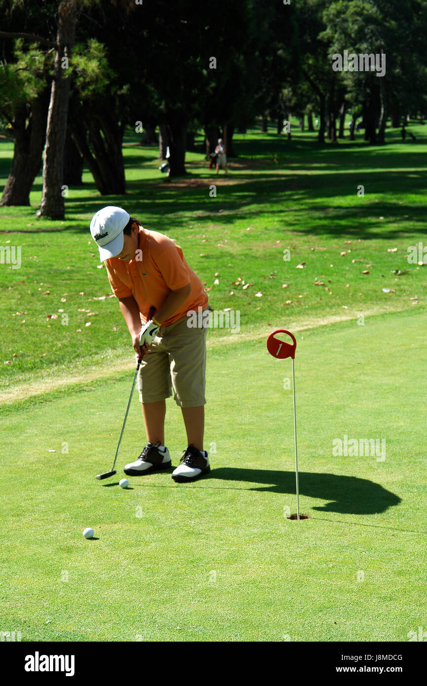 Golfer practicing on driving range Stock Photo - Alamy