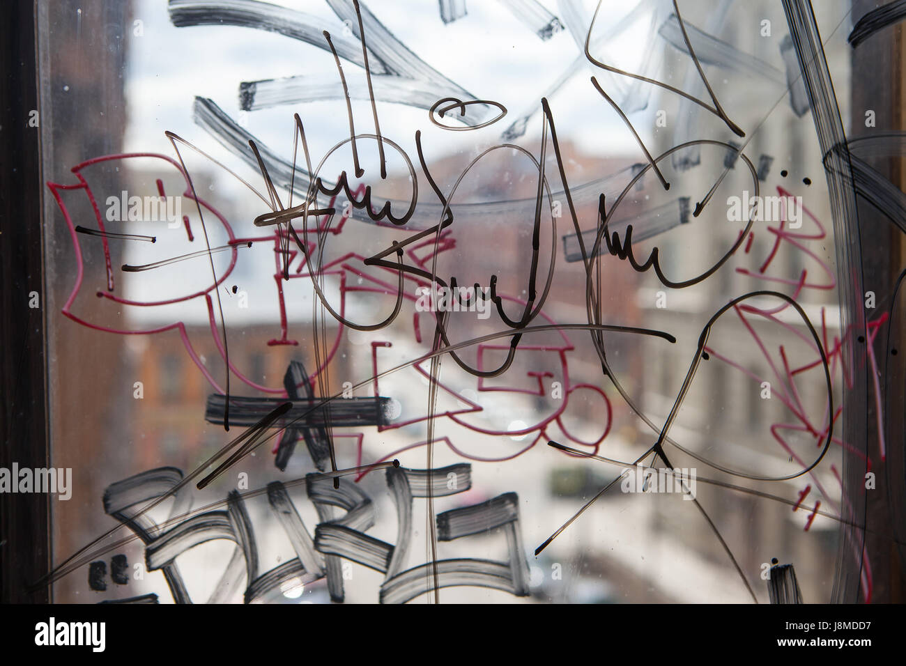 Vandal graffiti on the window of a house in the stairwell Stock Photo ...