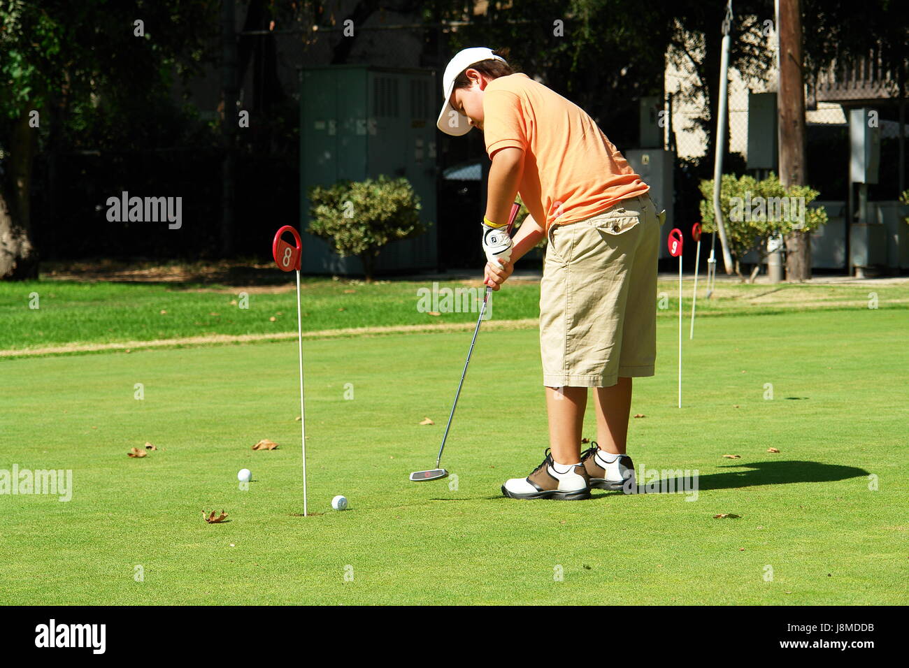 Golfer practicing on driving range Stock Photo - Alamy