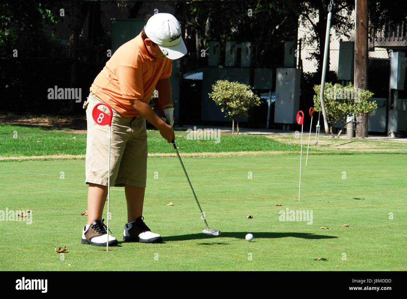 Golfer practicing on driving range Stock Photo - Alamy
