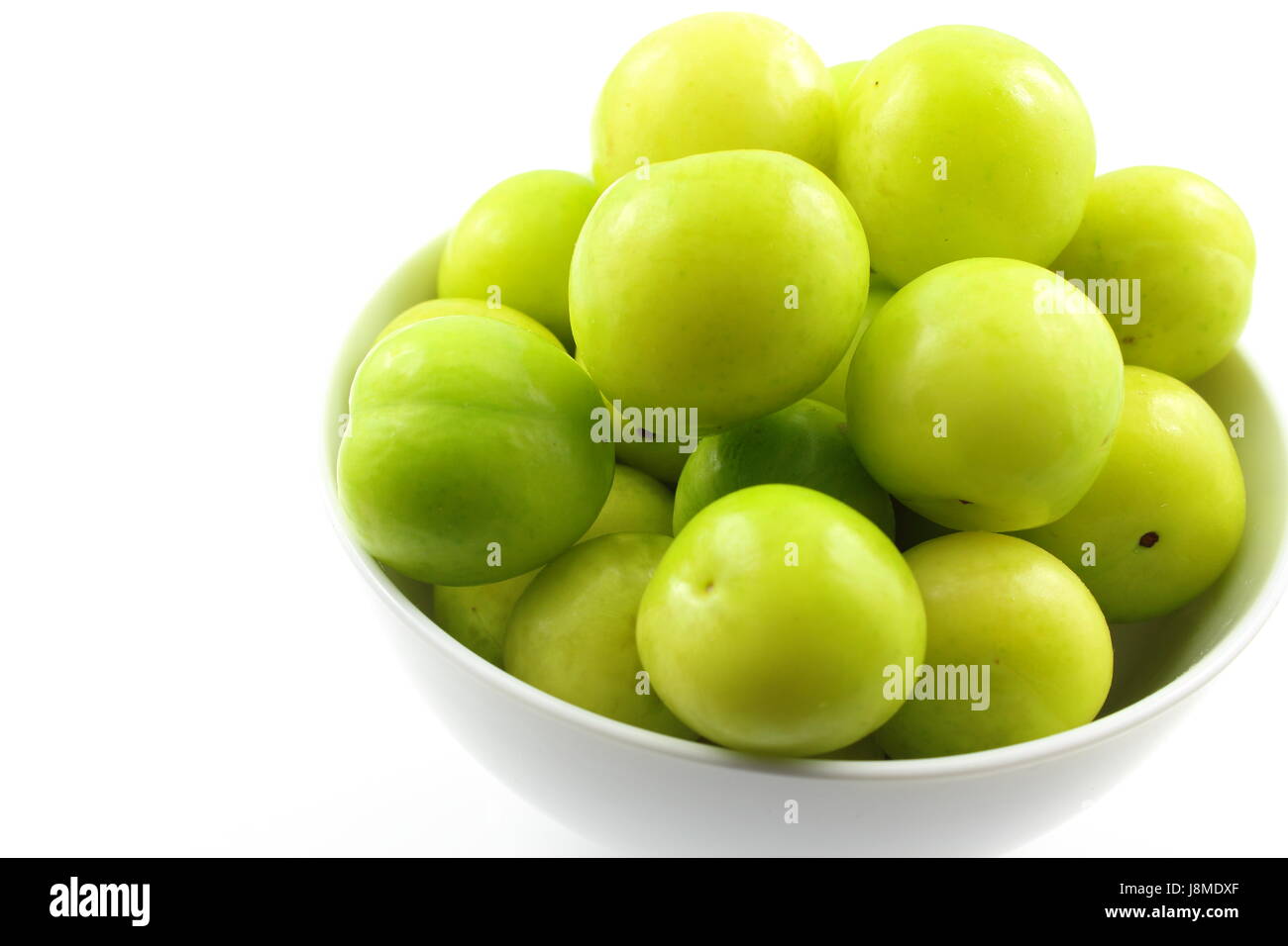composition of fresh turkish can erik plum fruits in a small white bowl ...