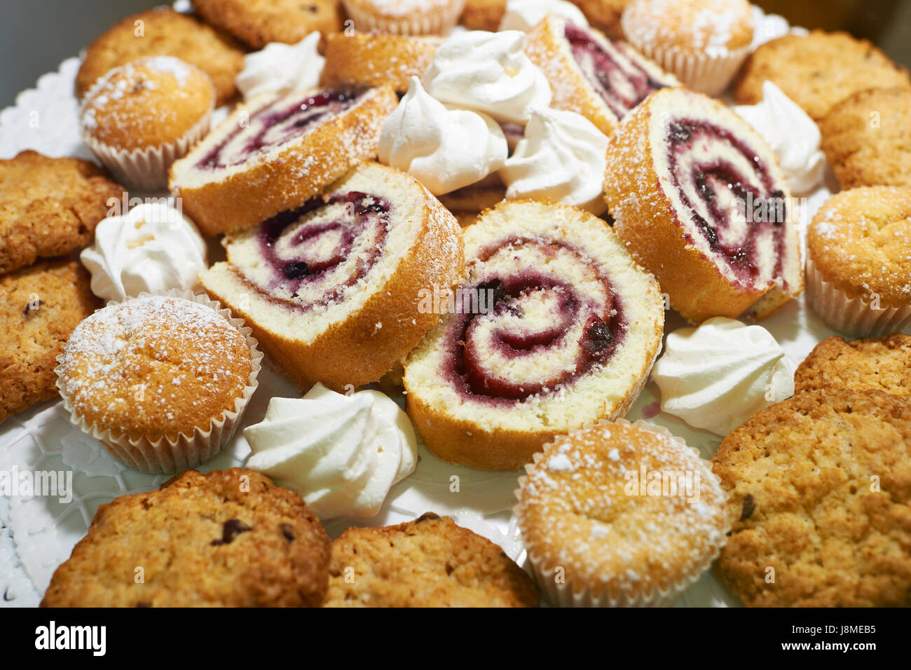 Cookies, cakes, meringue and sweet rolls with jam Stock Photo - Alamy