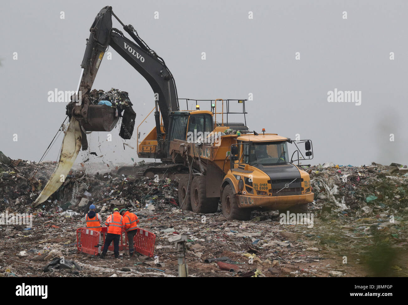 A digger moving waste at a landfill site in Pilsworth on the outskirts ...
