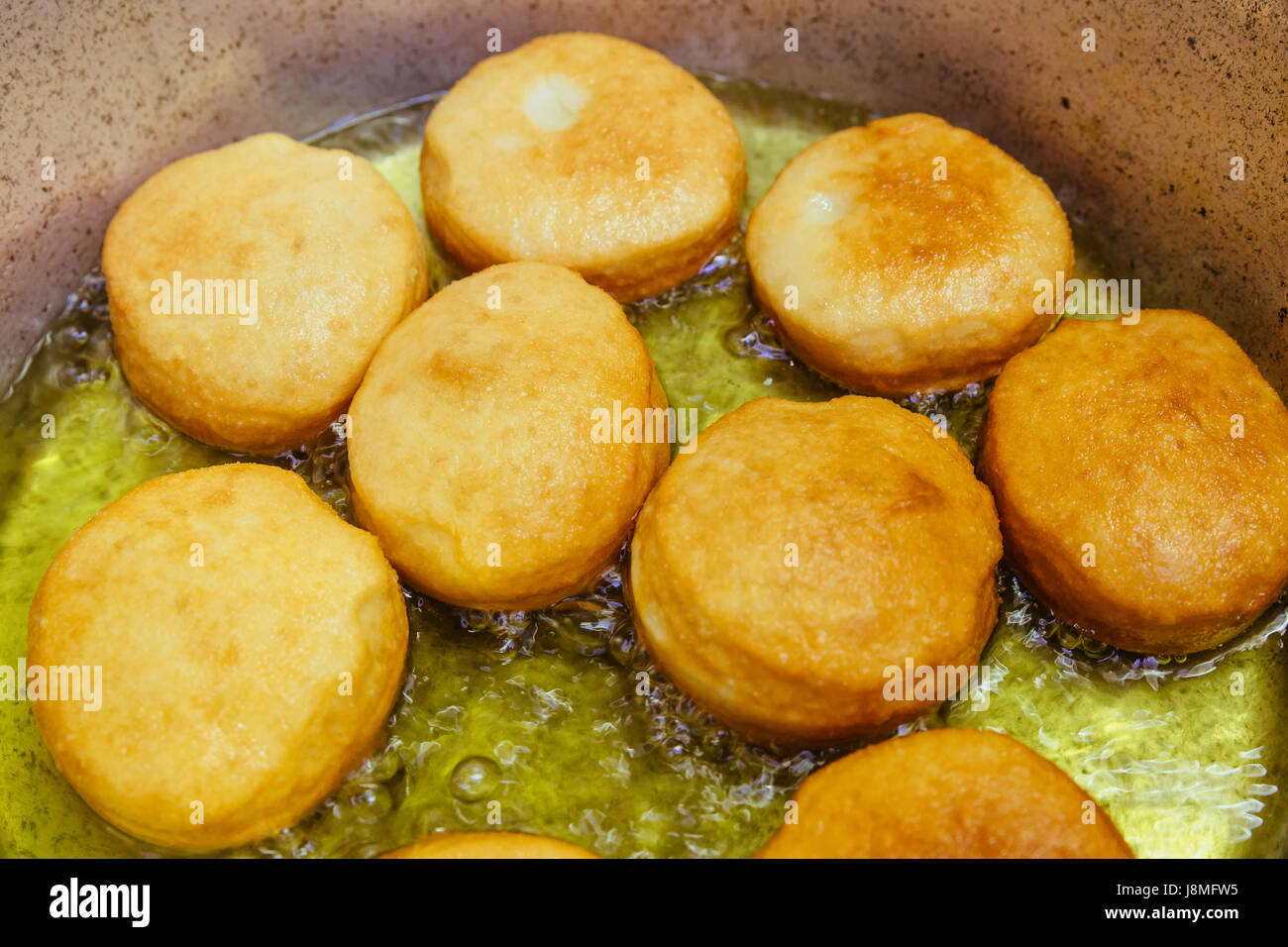 Donut frying in oil, close up video Donut frying Stock Photo - Alamy