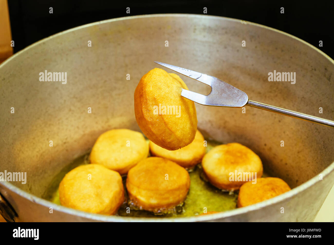 Donut frying in oil, close up video Donut frying Stock Photo - Alamy