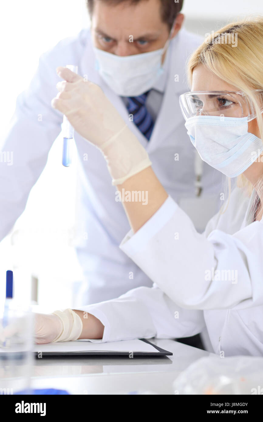 Scientific research team with clear solution in laboratory Stock Photo ...