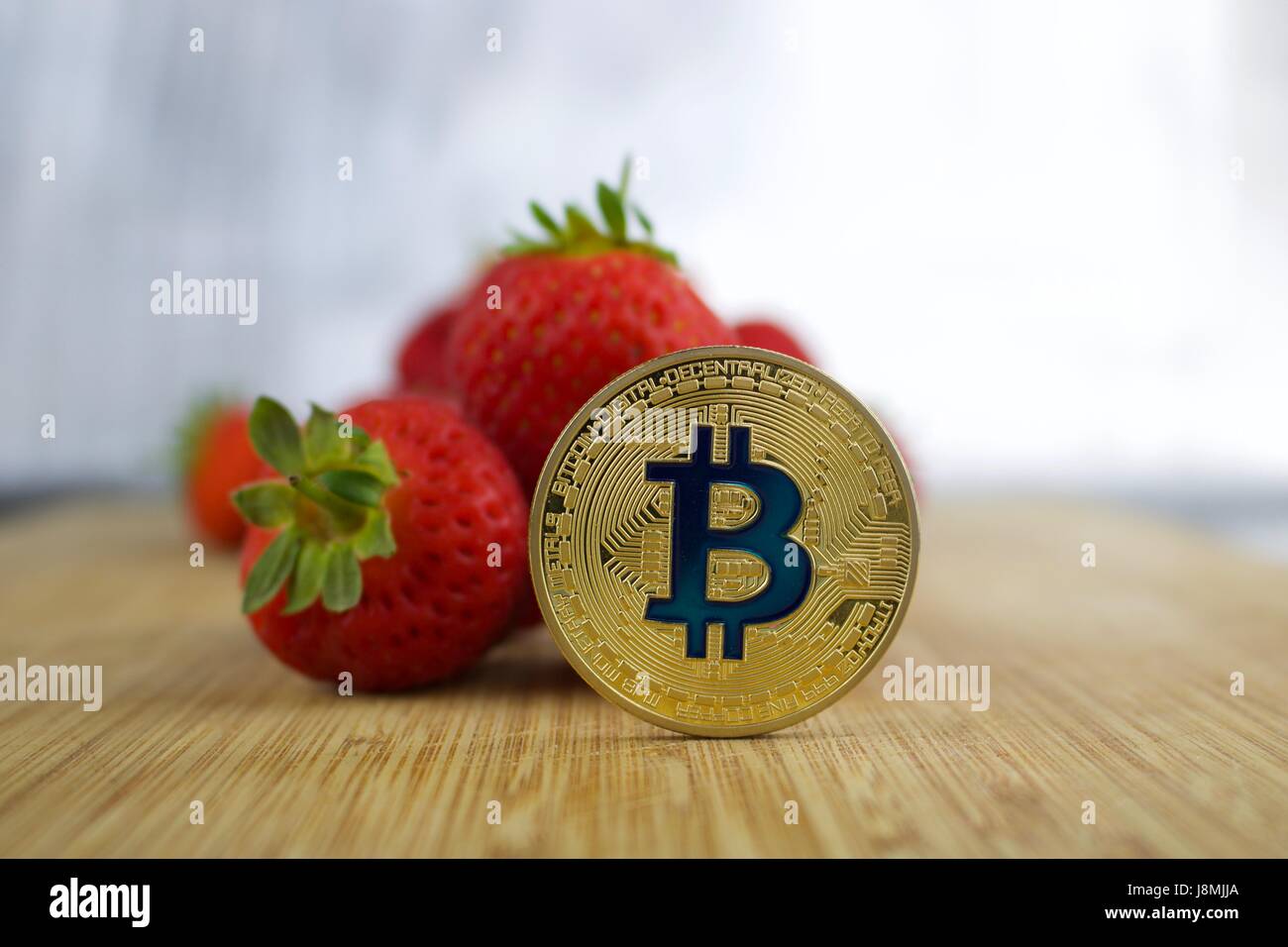 Cryptocurrency physical gold bitcoin coin in strawberry concept Stock ...