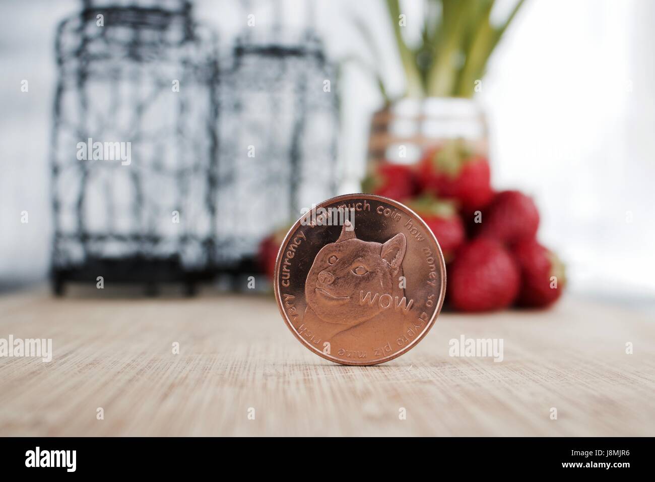 Digital currency brass doge coin and strawberry Stock Photo - Alamy