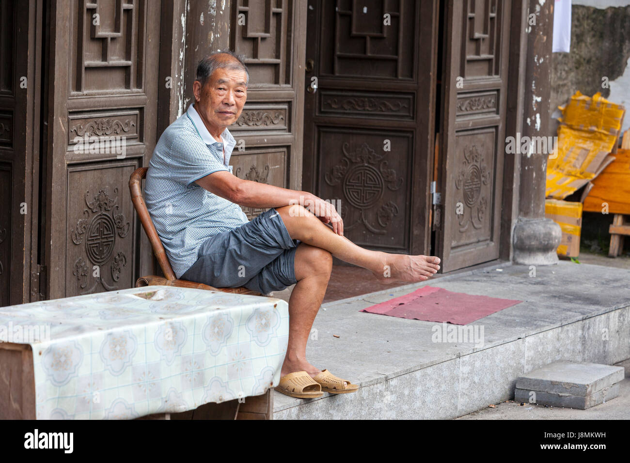 Yantou, Yongjia, Zhejiang, China. Middle-aged Man Sitting on his ...