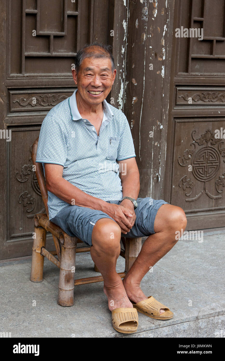 Yantou, Yongjia, Zhejiang, China. Middle-aged Man Sitting on his ...