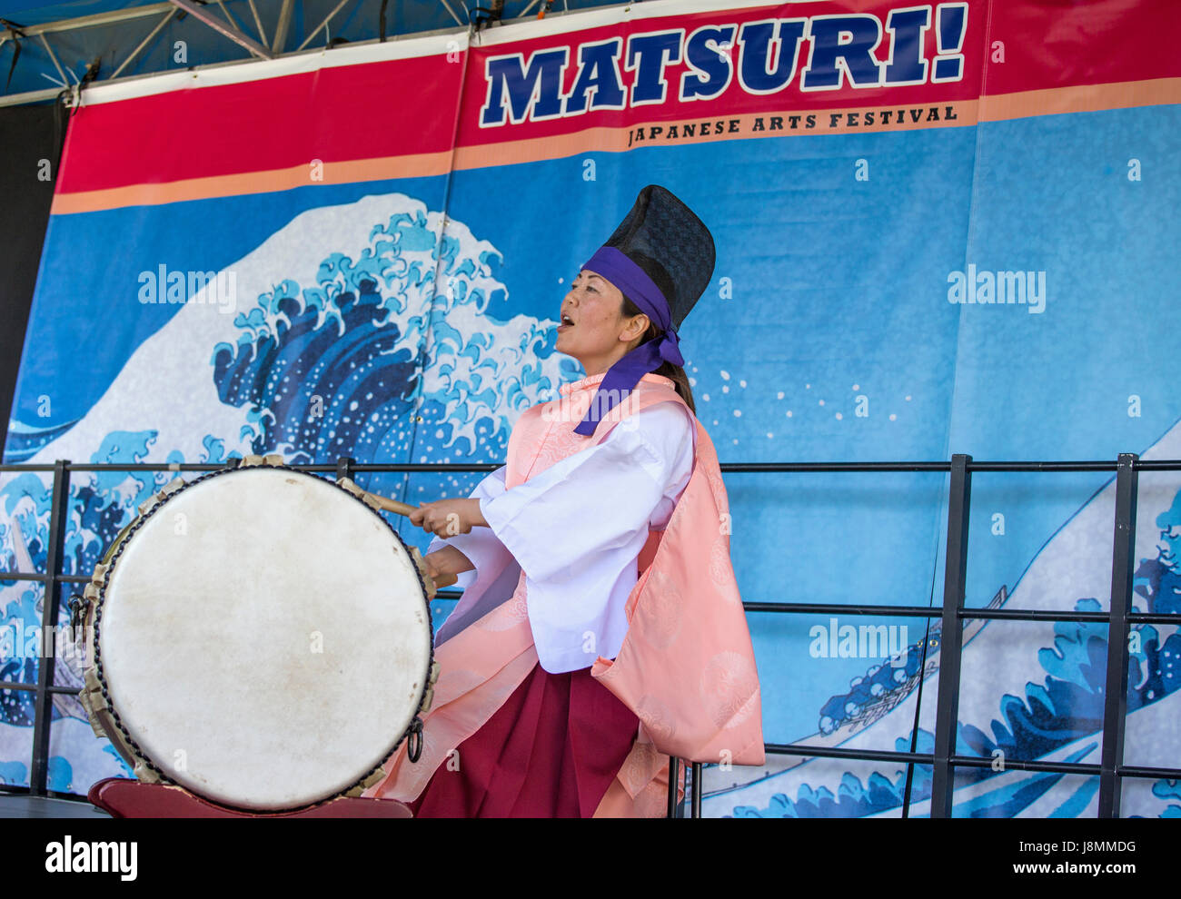 Member of TenTen Taiko playing taiko drum on stage at the annual ...